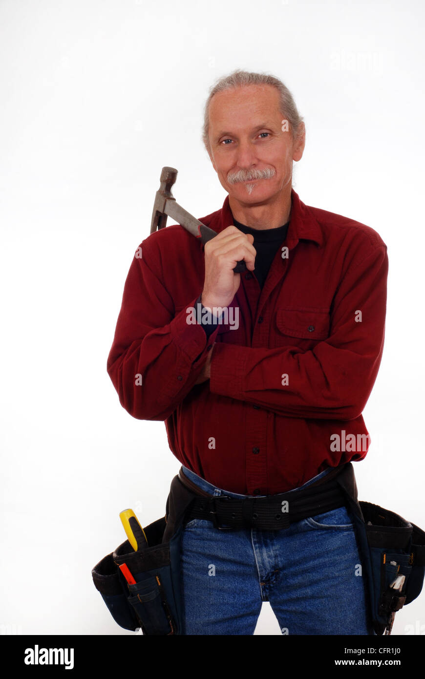 Smiling, male contractor holding a hammer, wearing tool belt Stock ...