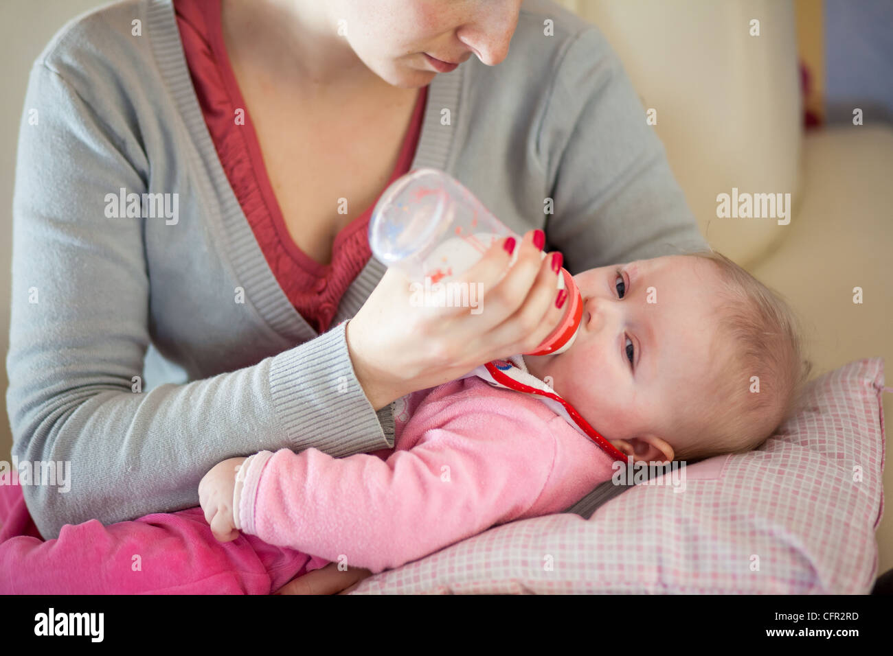 Mother feeding infant girl with baby formula Stock Photo - Alamy