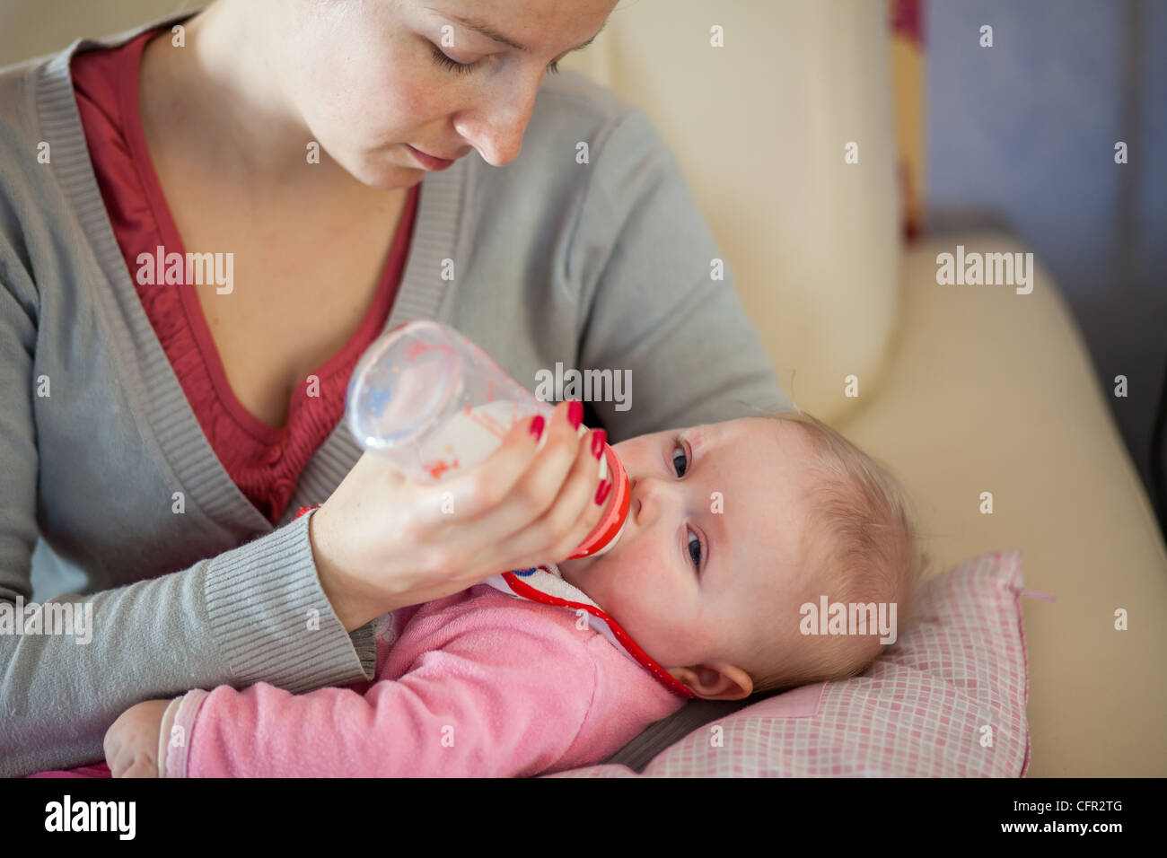 Mother feeding infant girl with baby formula Stock Photo - Alamy