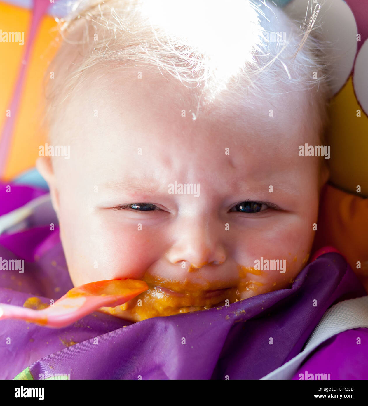 Teaching infant how to eat solid food Stock Photo - Alamy