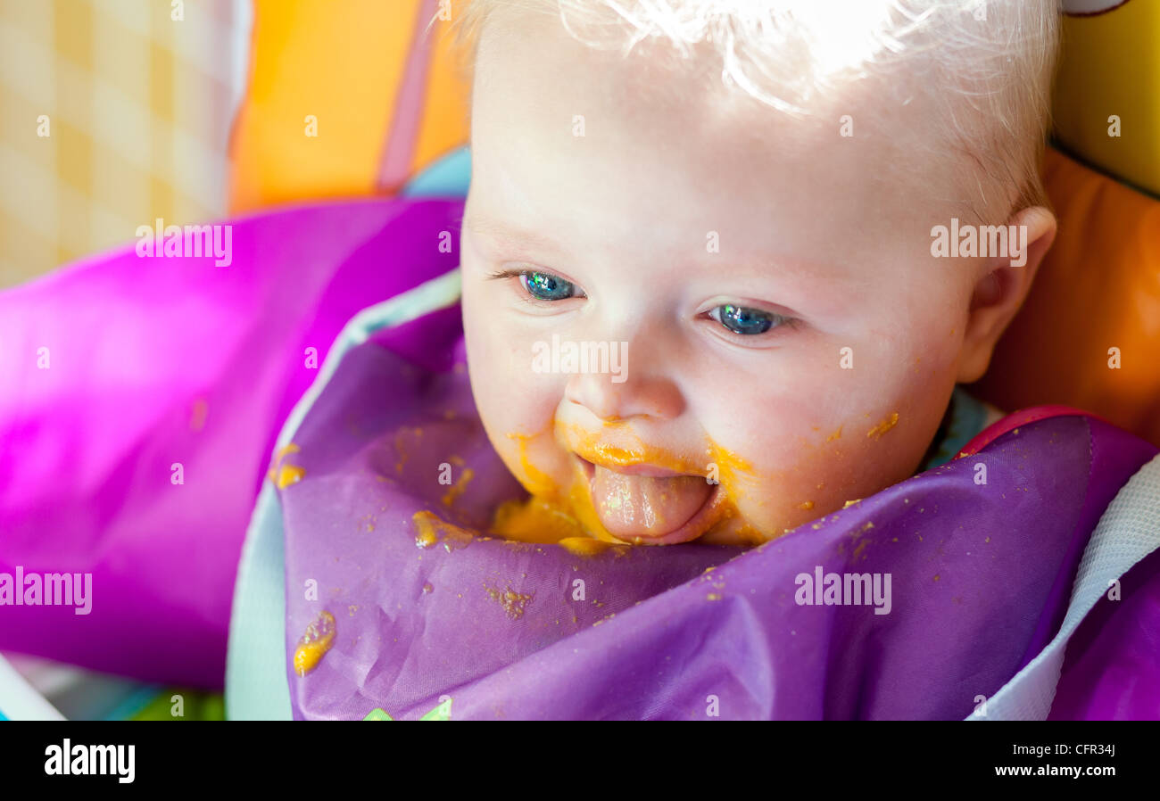 Teaching infant how to eat solid food Stock Photo - Alamy