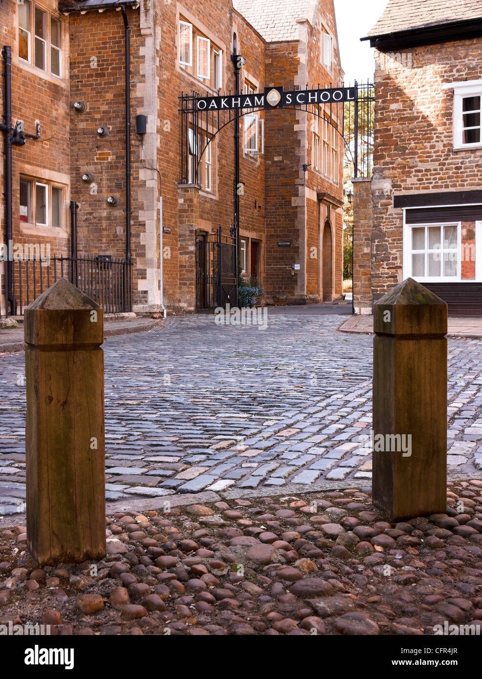 Wooden posts and stone cobbled entrance to Oakham School, Oakham market ...