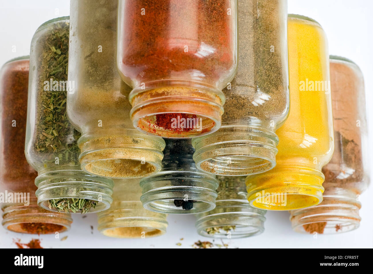 A studio shot of open spice jars balanced on top of each other in a ...