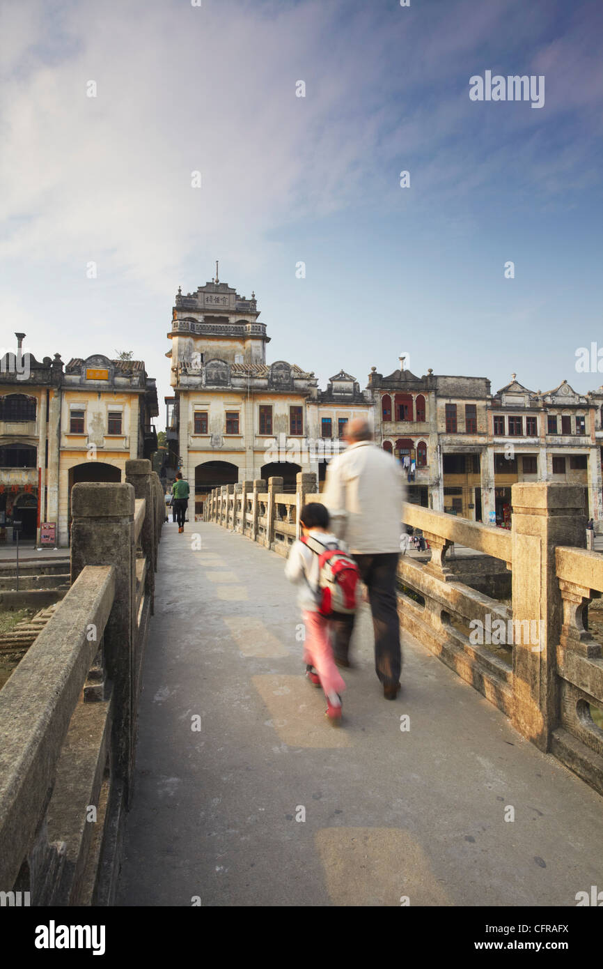 People crossing bridge in front of colonial architecture, Chikanzhen ...