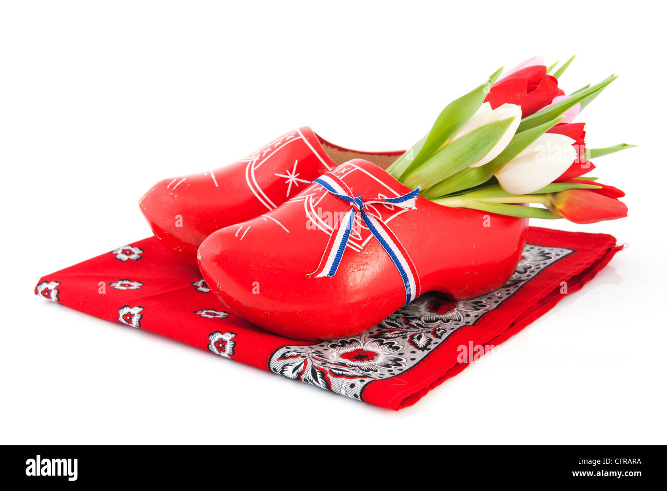 Red Dutch wooden clogs with colorful tulips on handkerchief Stock Photo ...
