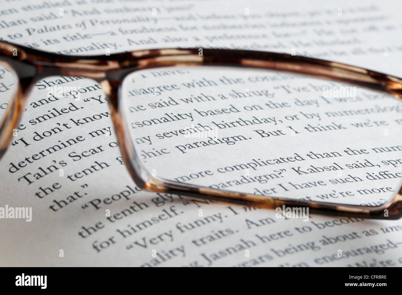 The text of a book seen through reading glasses Stock Photo - Alamy