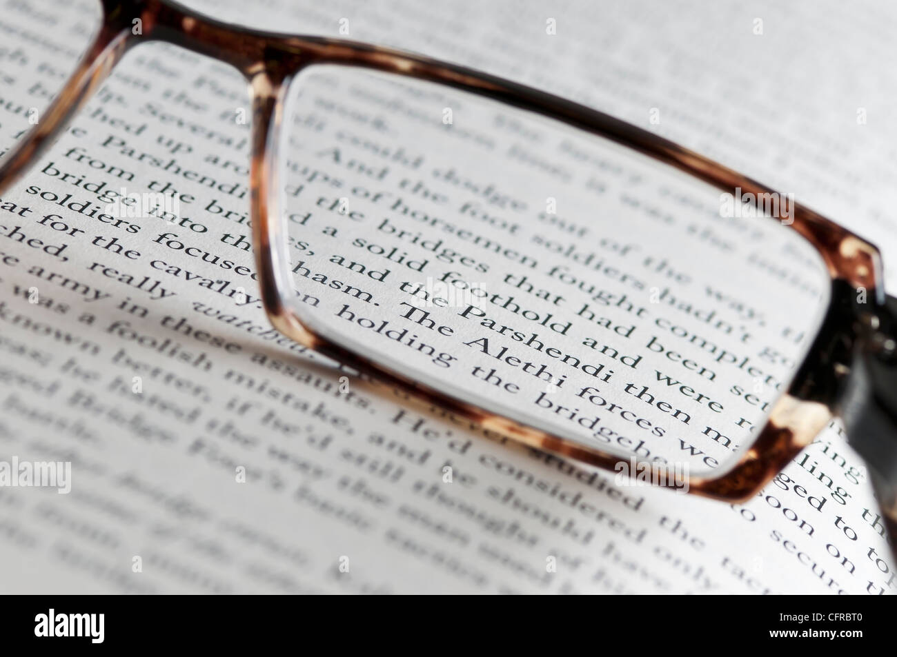The text of a book seen through reading glasses Stock Photo - Alamy