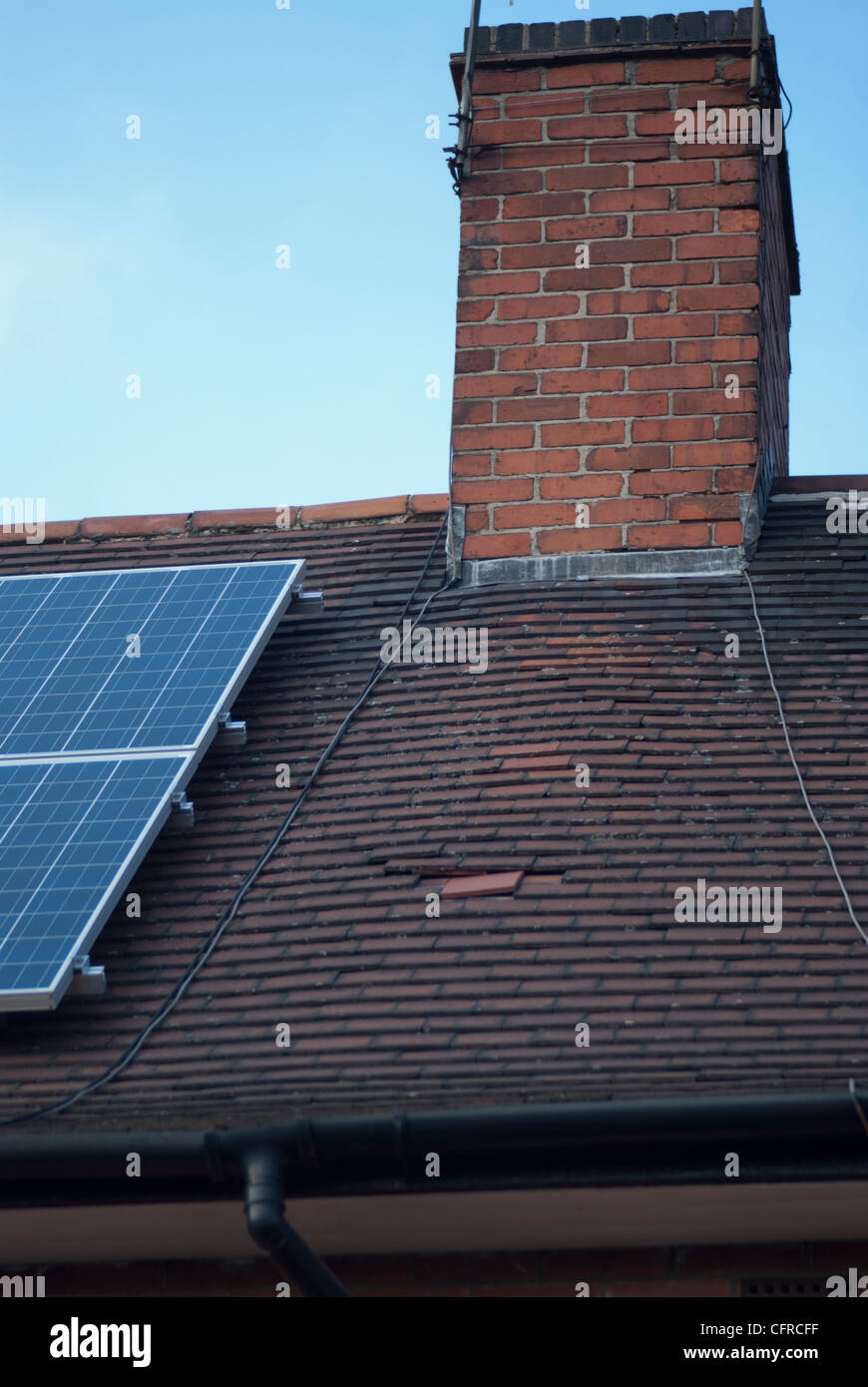 Damaged roof near solar panels Stock Photo - Alamy