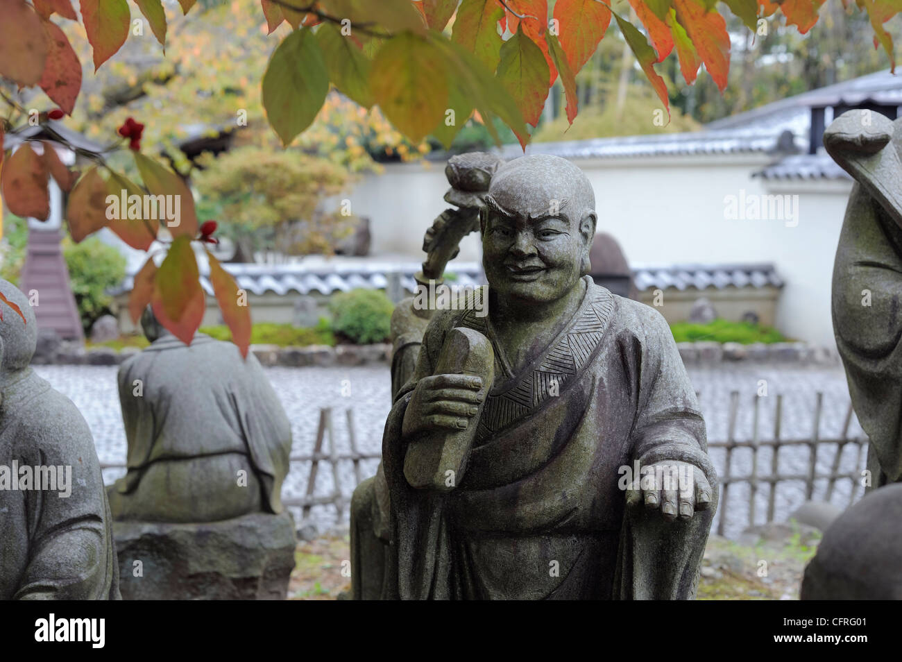 stone statues of Buddhist monks and autumn leaves in Arashiyama, Kyoto ...