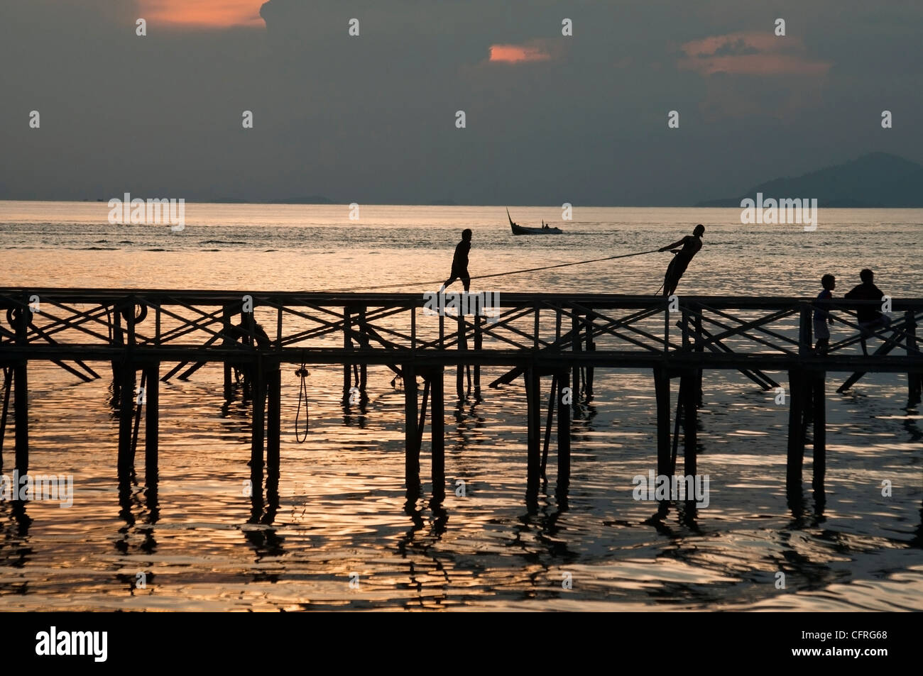 fishermen at sunset on Mabul Island, Borneo, Malaysia Stock Photo - Alamy