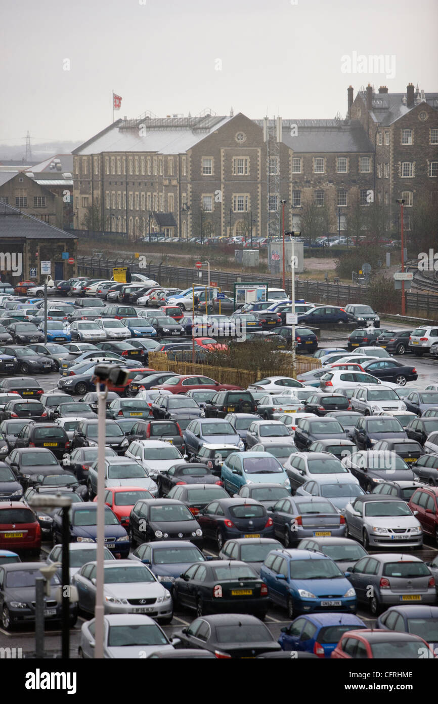 Large car park full of cars parked in front of the headquarters of ...