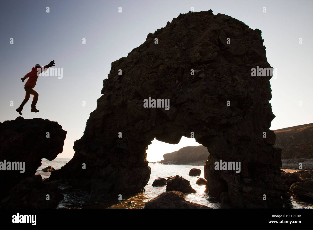 Man jumping rock coast hi-res stock photography and images - Alamy