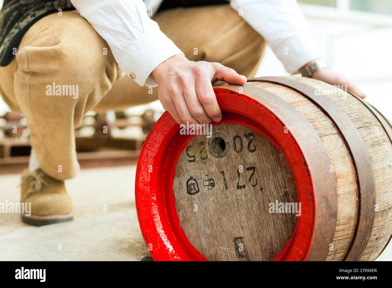 A brewer in his brewery is loading a beer barrel Stock Photo - Alamy