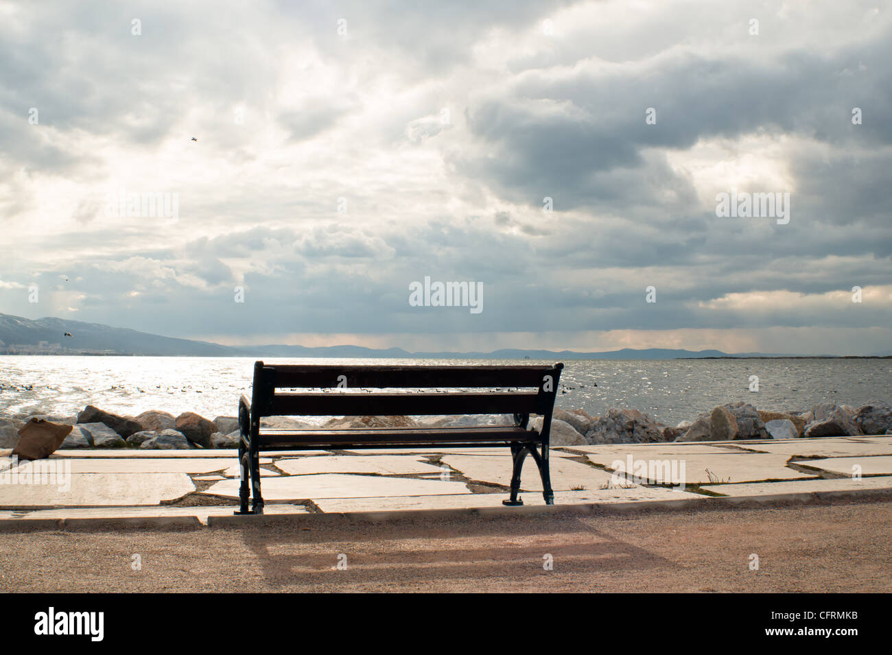 Empty low stool at the coast of the cloudy blue sea Stock Photo - Alamy