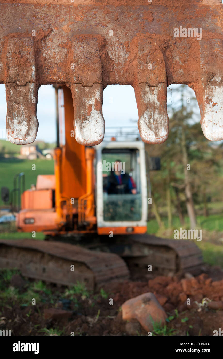 Big excavator digging stone on a hillside Stock Photo - Alamy