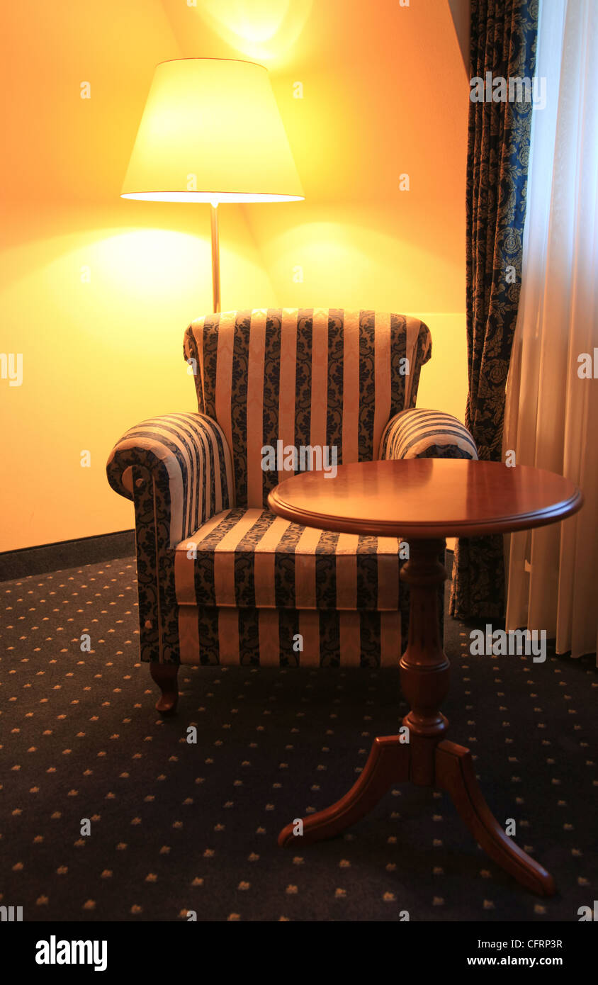 Chair,lamp and small wooden table Stock Photo - Alamy
