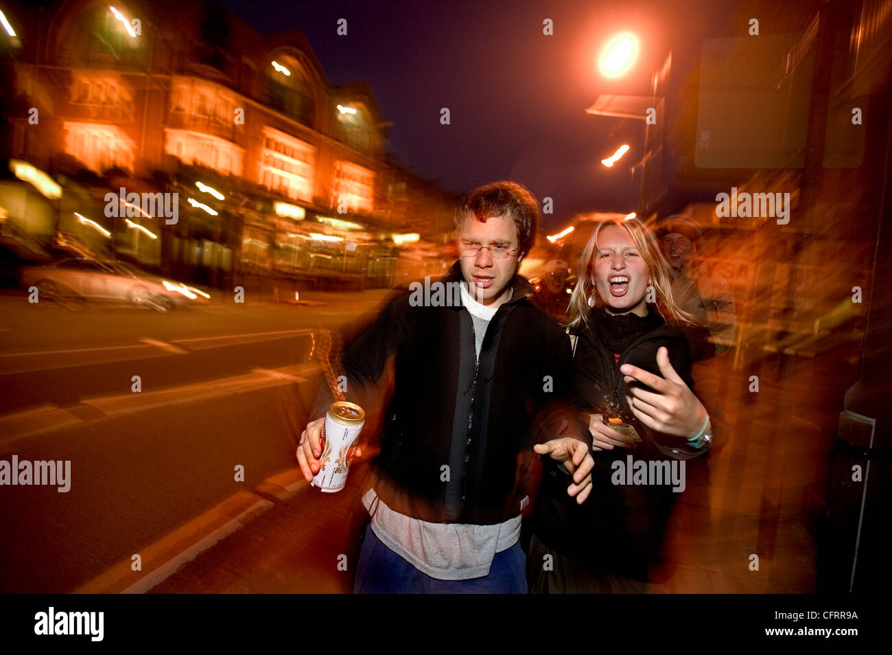 Group of drunks, one throwing beer at the photographer. North London ...