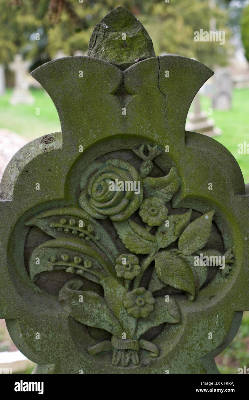 Gravestone with carving of flowers in graveyard of rural St Mary's ...