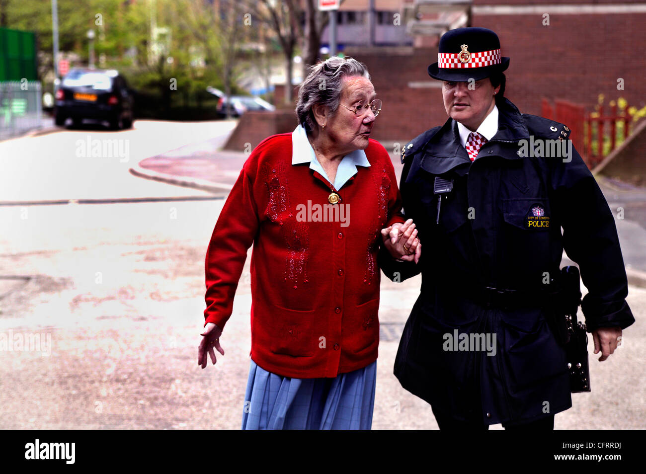 City of London Policewoman helping an elderly woman in an Aldgate ...