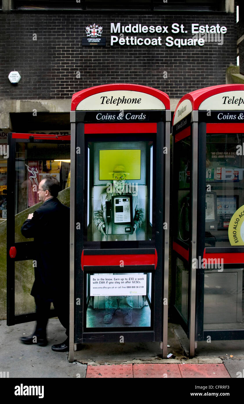 man leaving a London telephone box Stock Photo - Alamy