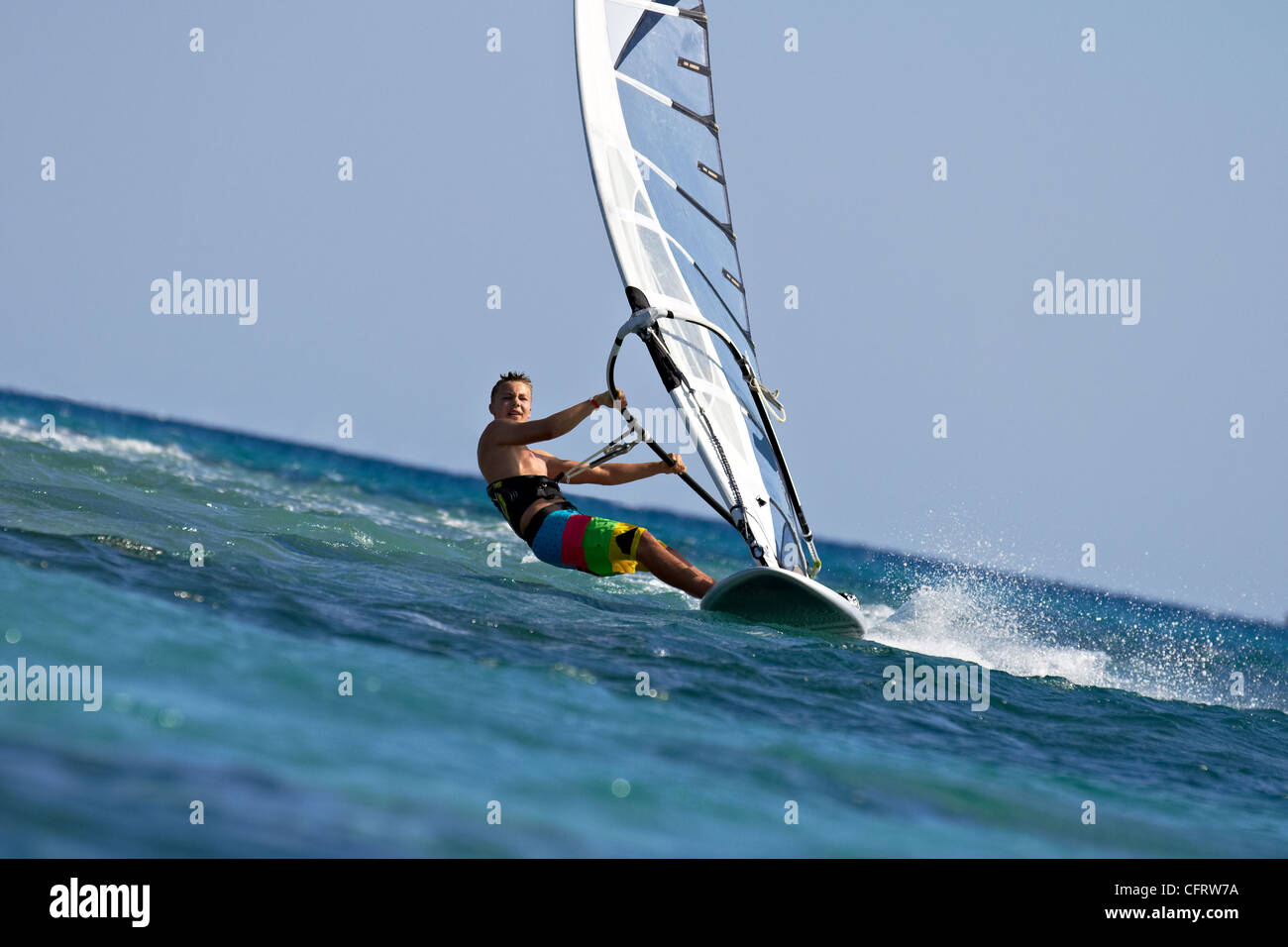 Fast approaching windsurfer mooving almost horizontally Stock Photo - Alamy