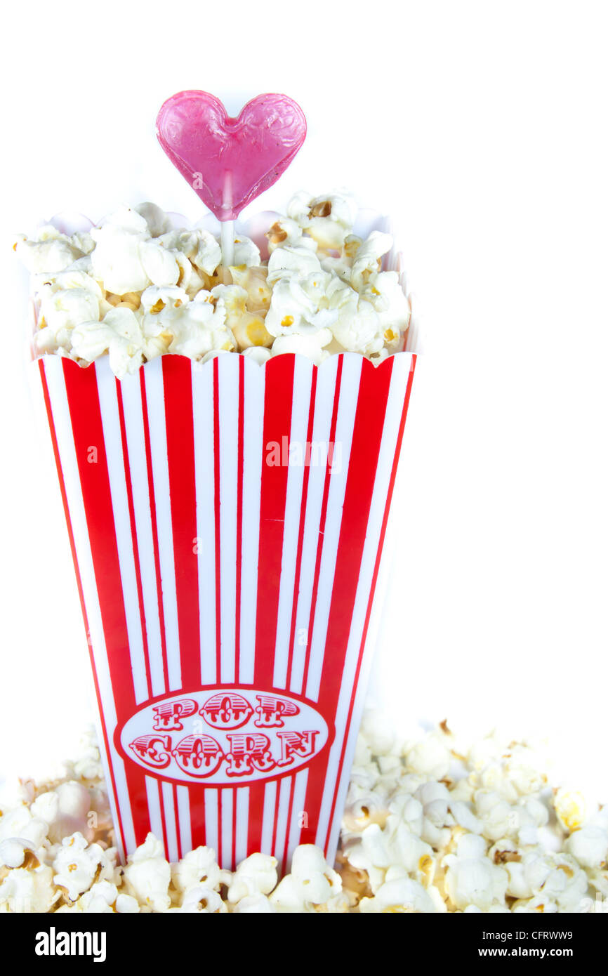 Picture of a box with popcorn with a heart candy in it Stock Photo - Alamy