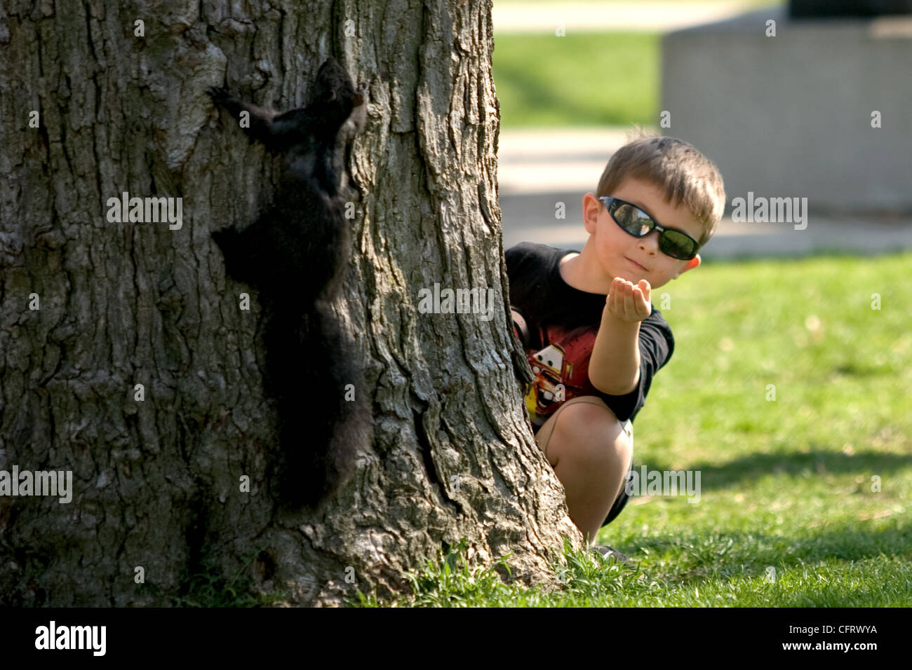 Caleb Clarkson tries his best to feed a squirrel from his hand in ...