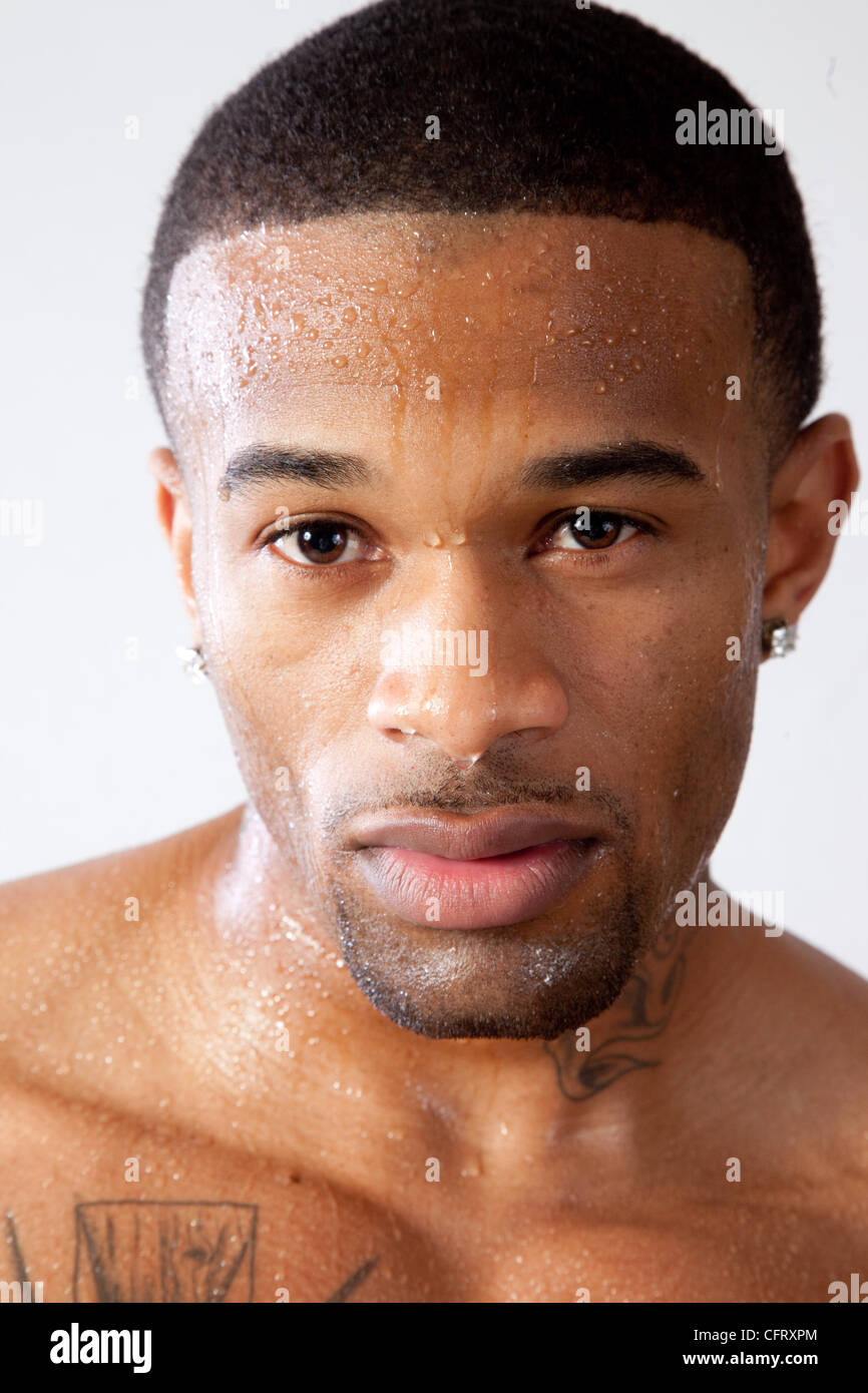 Handsome black man shirtless and looking to the left with a quiet and ...