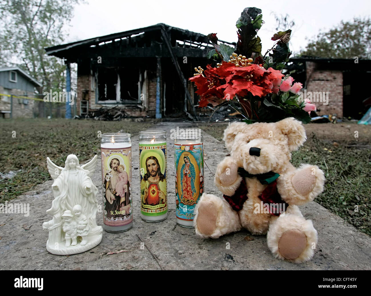METRO ----- Candles, flowers, an angel and a stuffed bear are seen ...