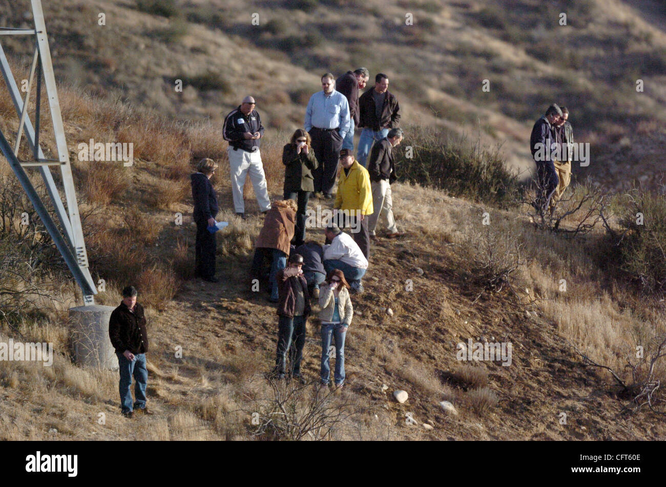Family and friends mourn above the crash site Monday afternoon where a ...