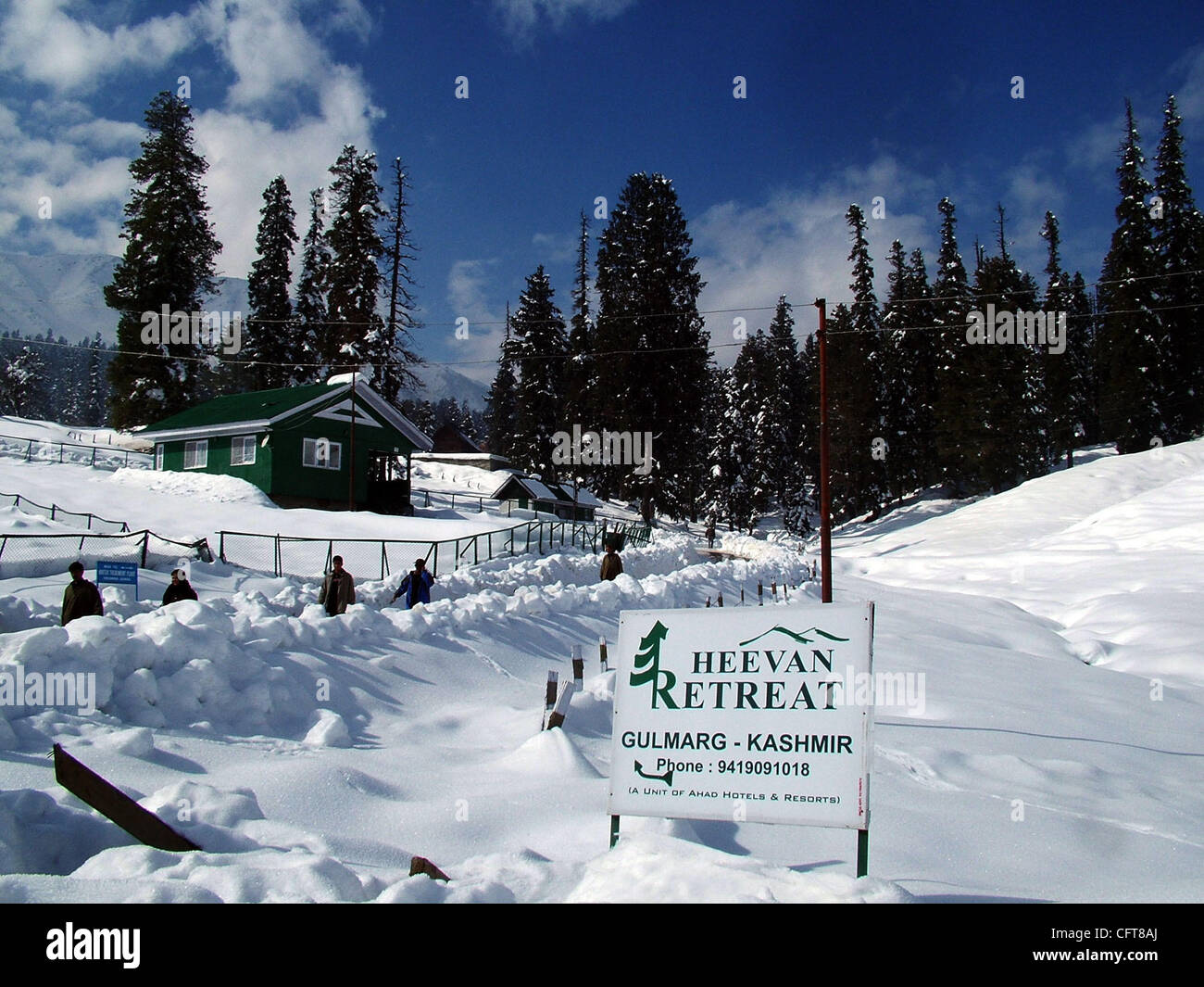 A beautiful view of snow covered trees and houses in gulmarg kashmir ...