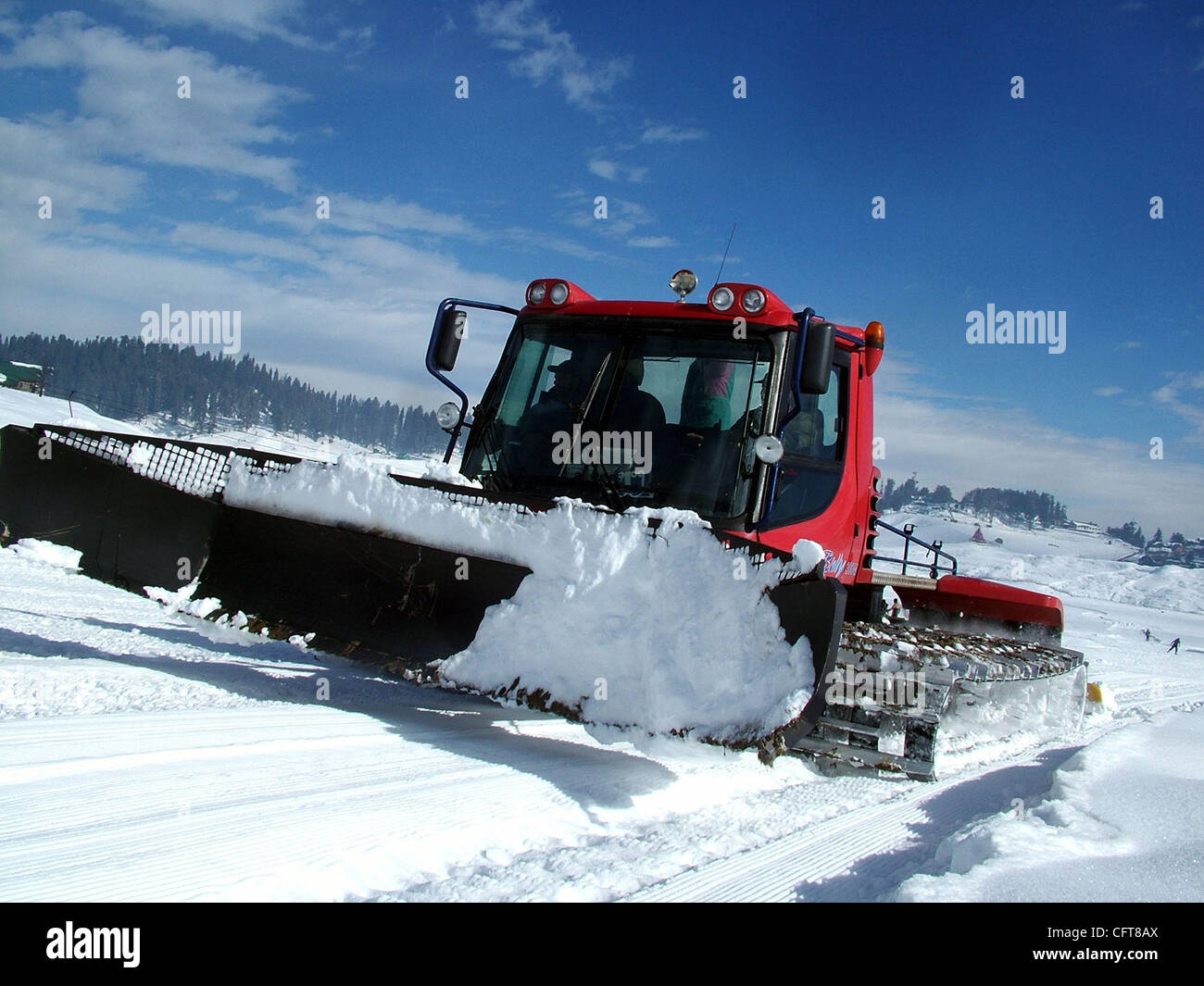 Machine workres busy in shaping snow at a field at these fields are ...