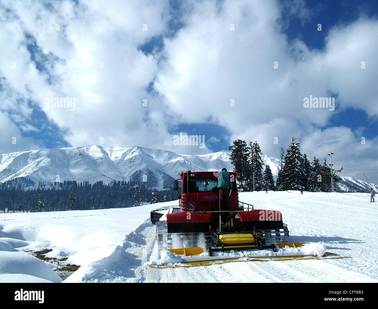 Machine workres busy in shaping snow at a field at these fields are ...