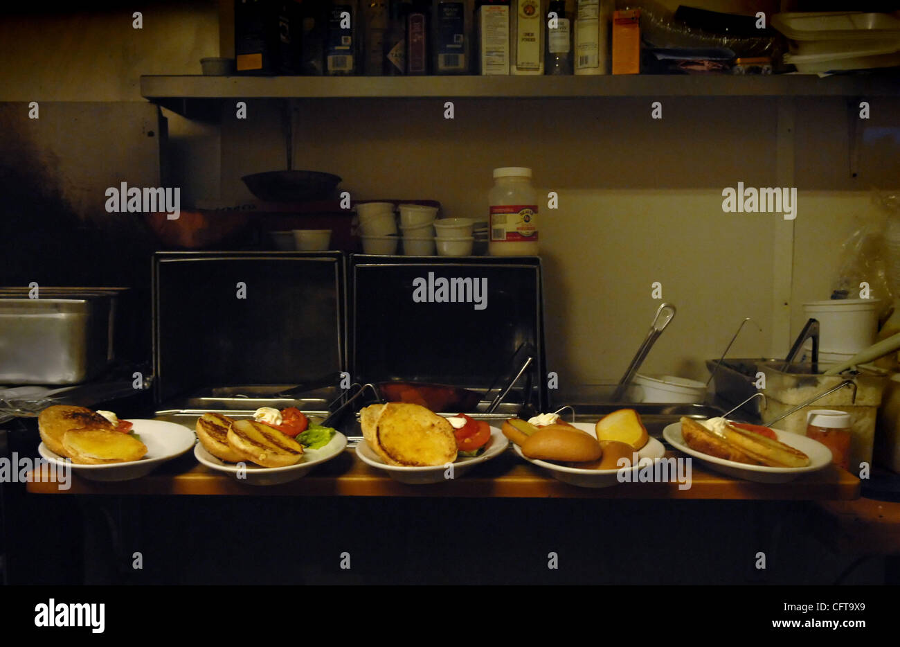 Plates sit in the kitchen like an assembly line awaiting the finishing ...