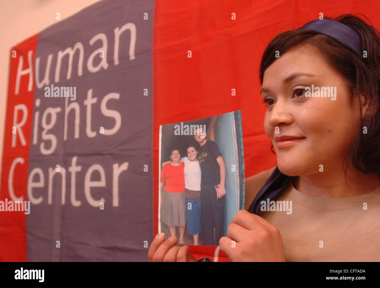 Angela Fillingim, 21, holds a photo of her brother, birth mother and ...