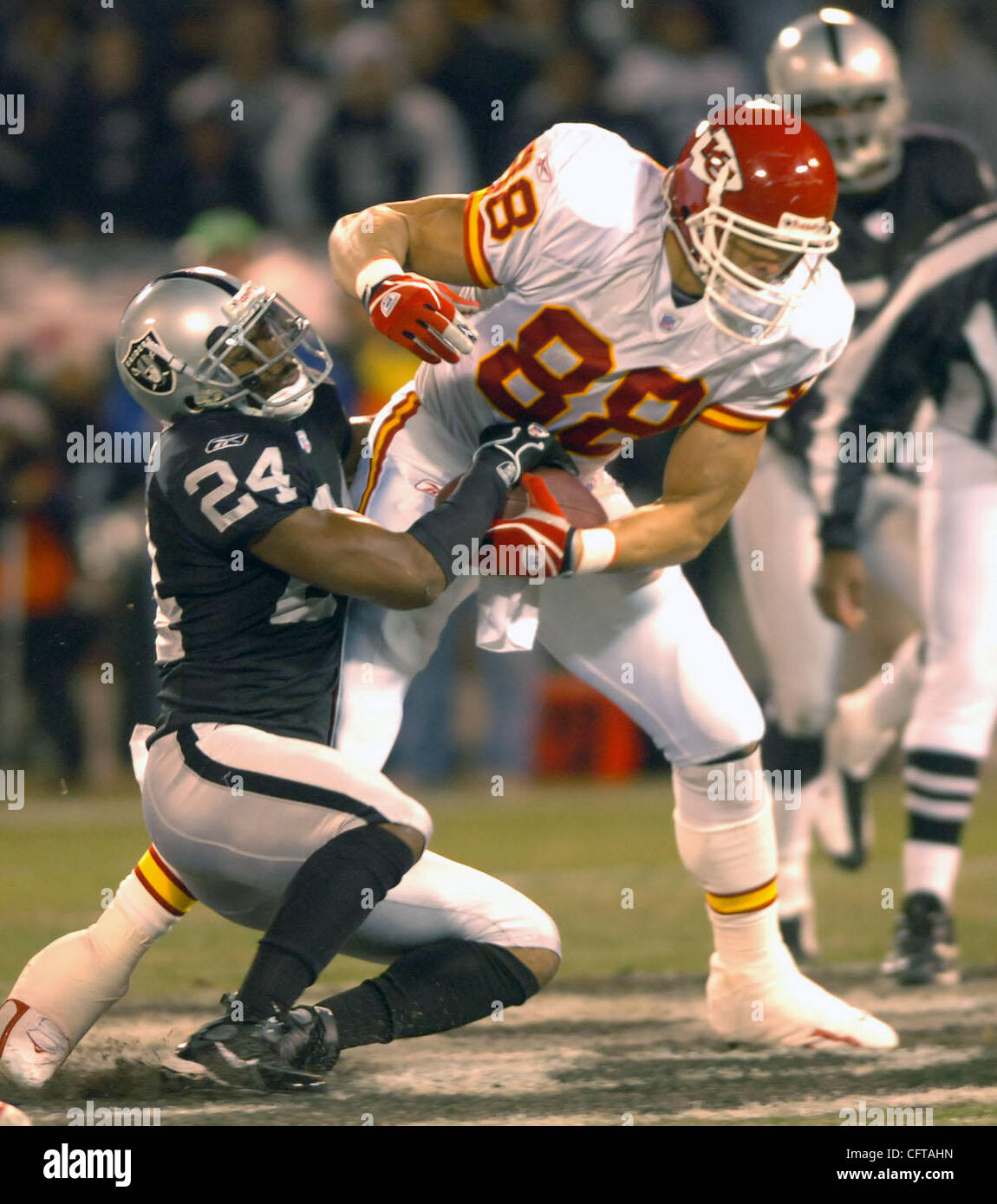 Oakalnd Raider Michael Huff (#24) stops Chiefs tight end Tony Gonzalez ...
