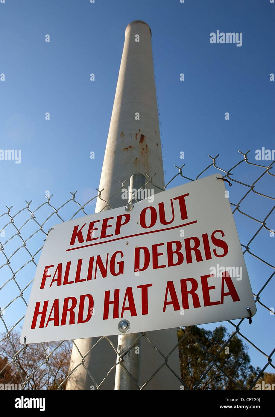 A sign at the Cowell Cement Plant Smokestack warns of falling debris on ...