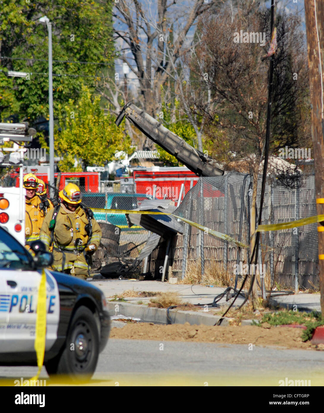 Firefighters walk past a twin-engine Cessna 525 business jet crashed ...