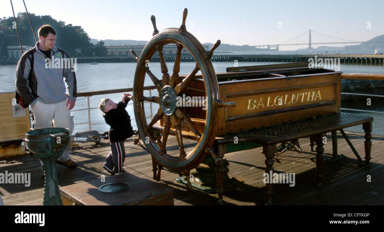 2-year-old Ashton Vinson puts his hand to the wheel as his father Lucas ...
