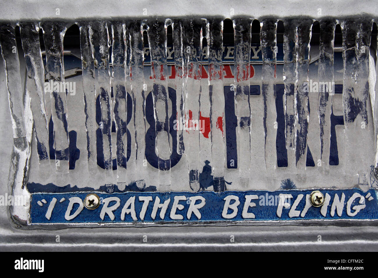 METRO- A vehicle license plate is covered with icicles parked at the ...