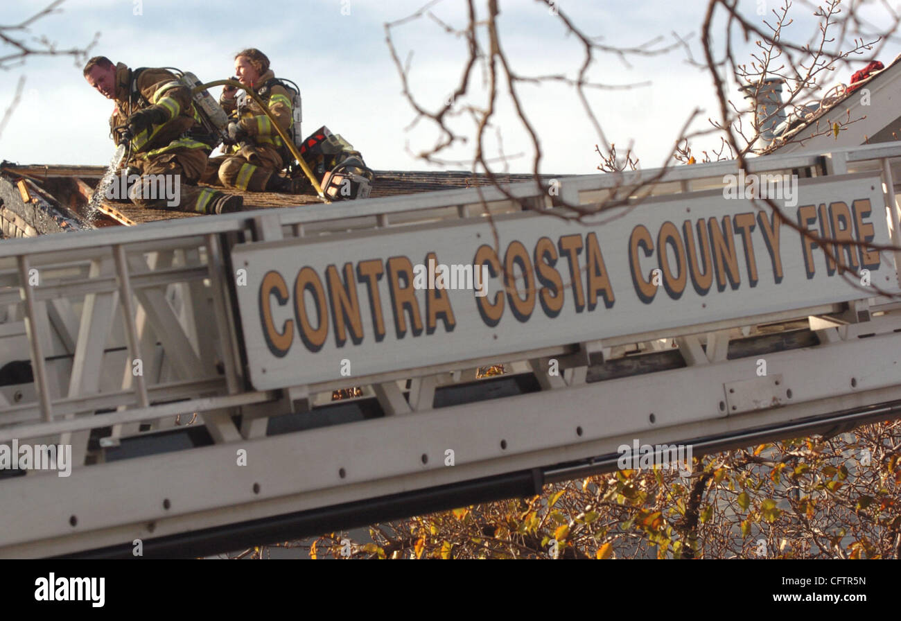 Contra Costa County Fire attend to a 2-alarm townhouse roof that caught ...