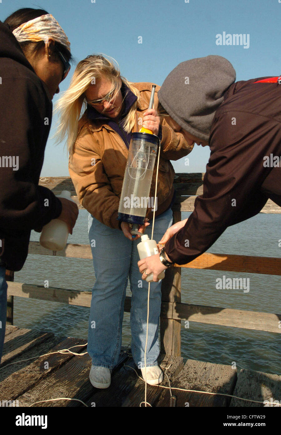 Kathy Fessler (center) collects water samples with a Kemmerer Water ...
