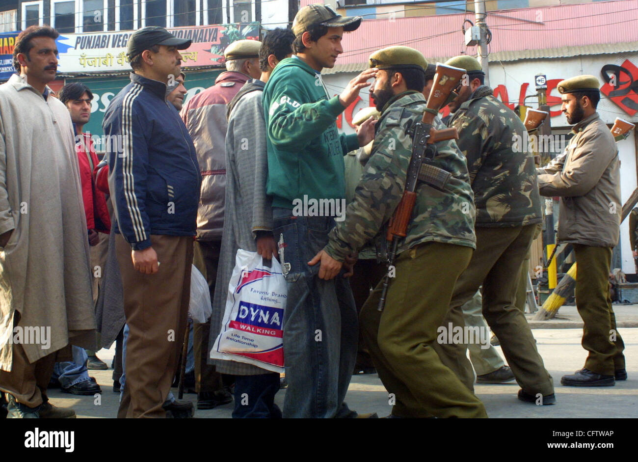 Indian police men check people during crack down in srinagar. security ...