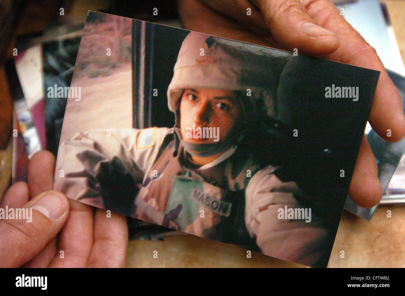 Emile Meylan holds a family photo of his daughter Army veteran truck ...