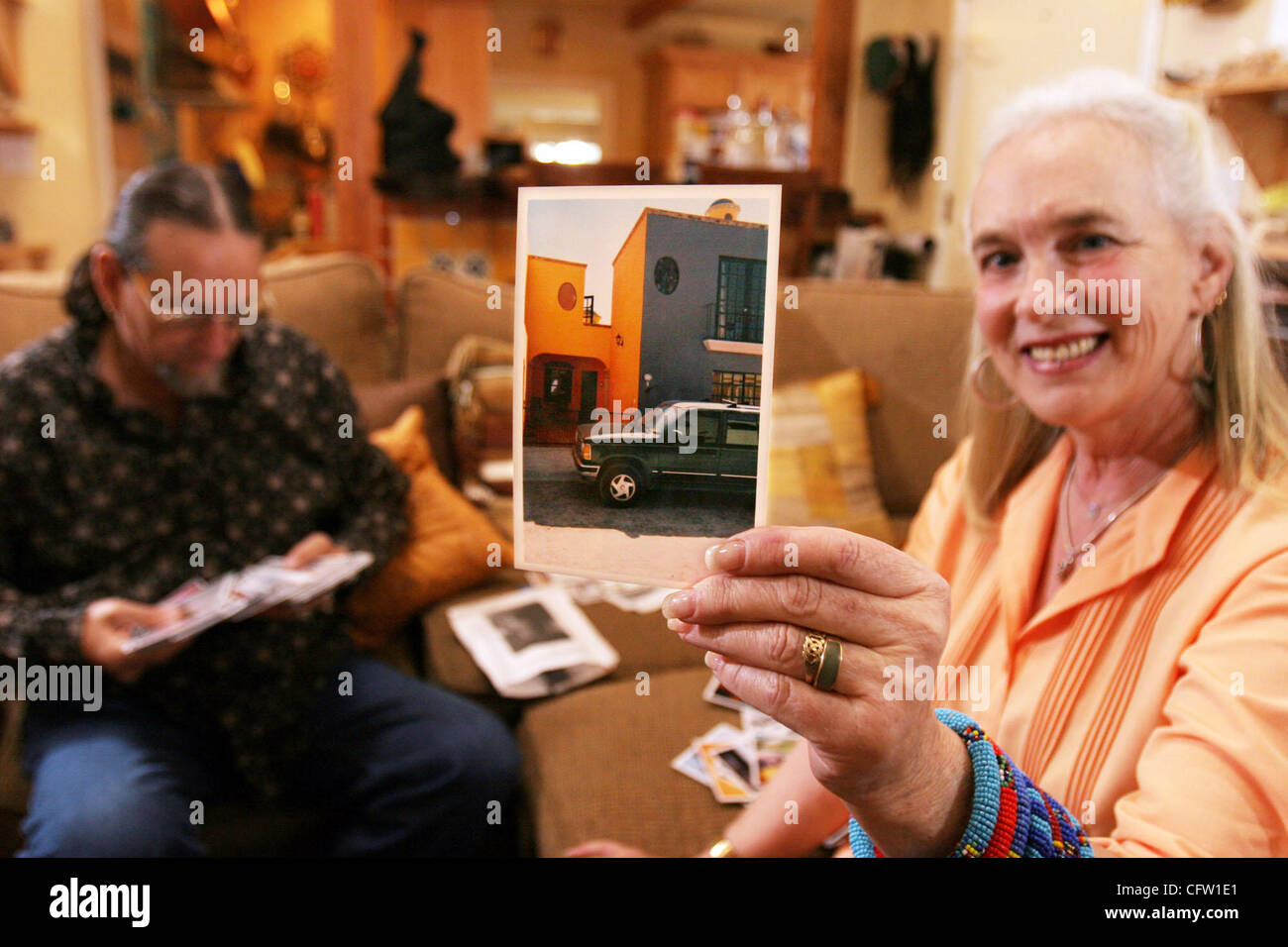 Susan Mintz, right, of Oakland, Calif., shows a picture of the house ...