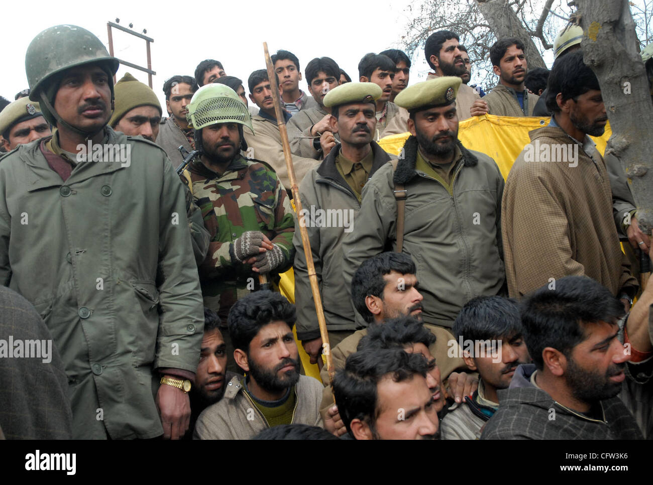Security men and people watch the unseen body passing by of Showkat ...