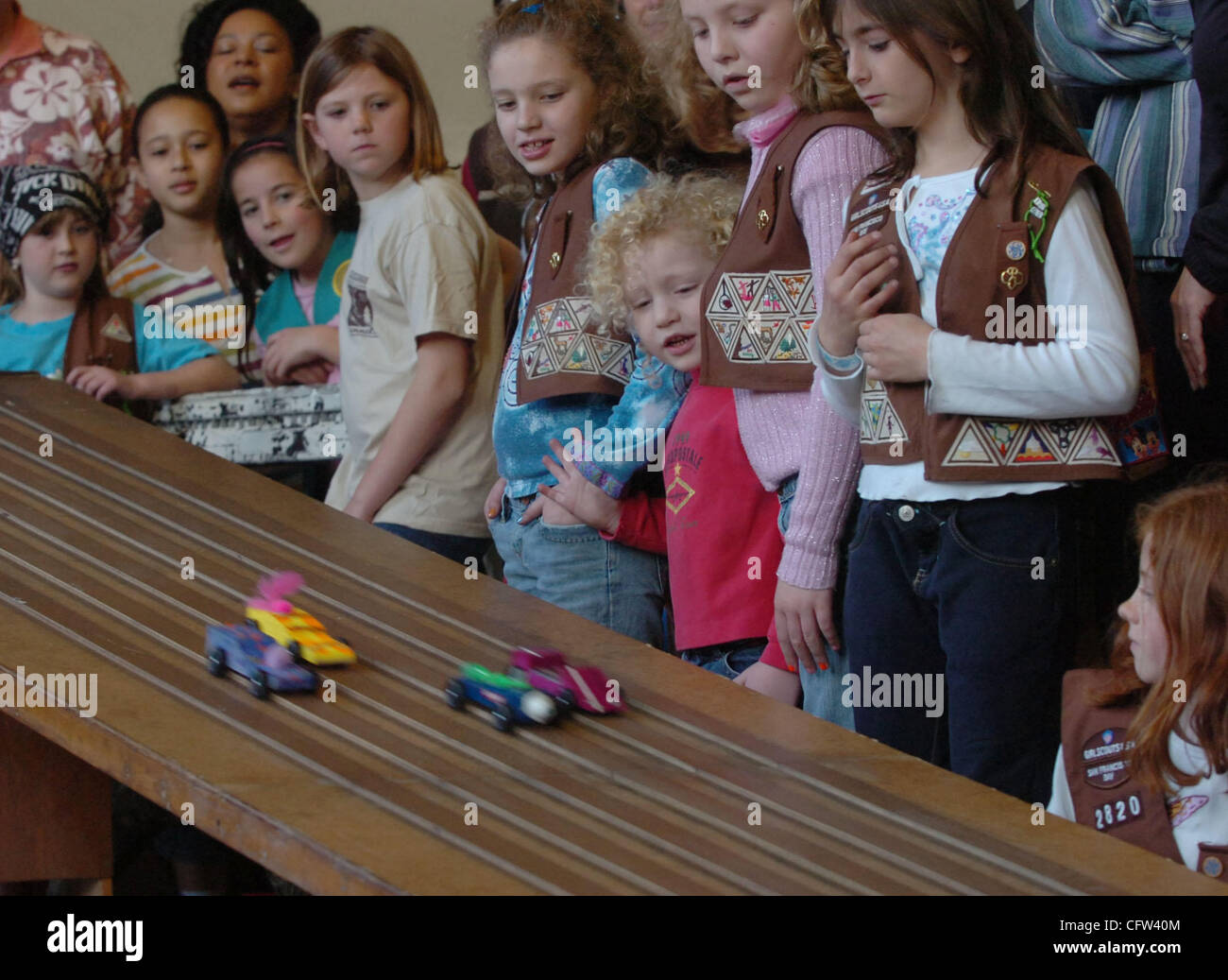 Friends and family watch local Girl Scouts race their cars during ...