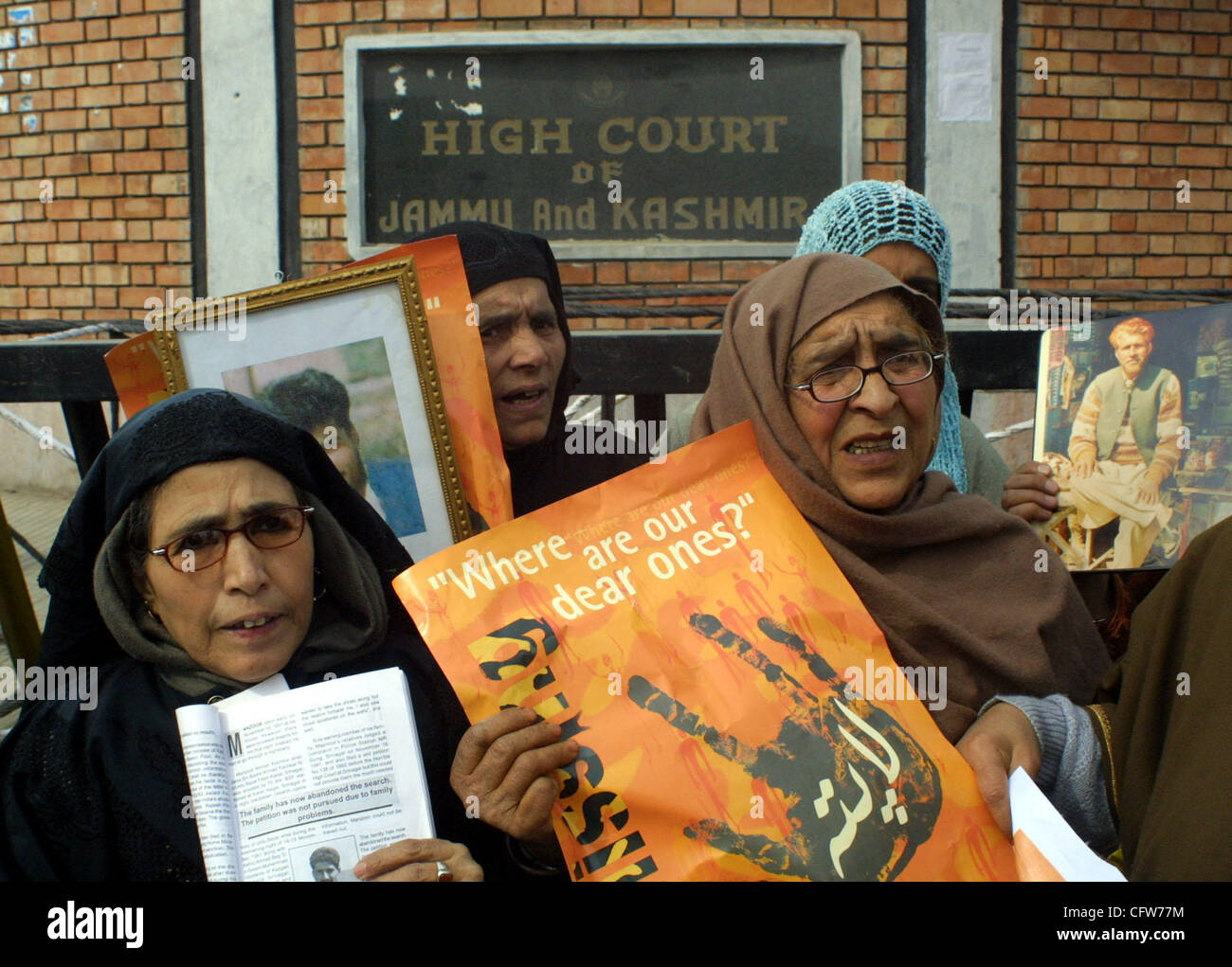 Kashmiri women carrying photographs of their missing relatives during a ...