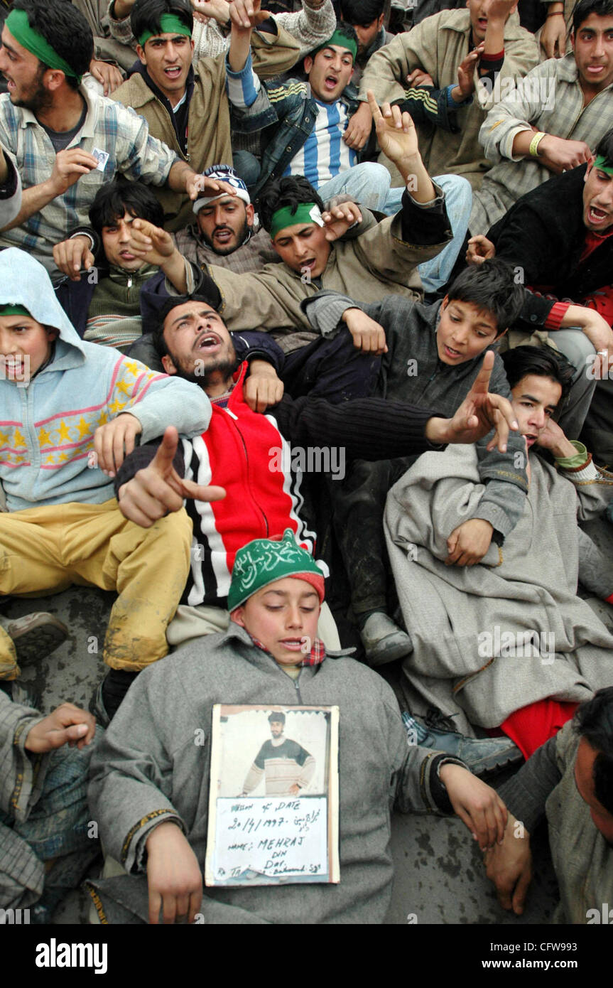 Protesters shout anti-police slogans as they lie down on a road during ...