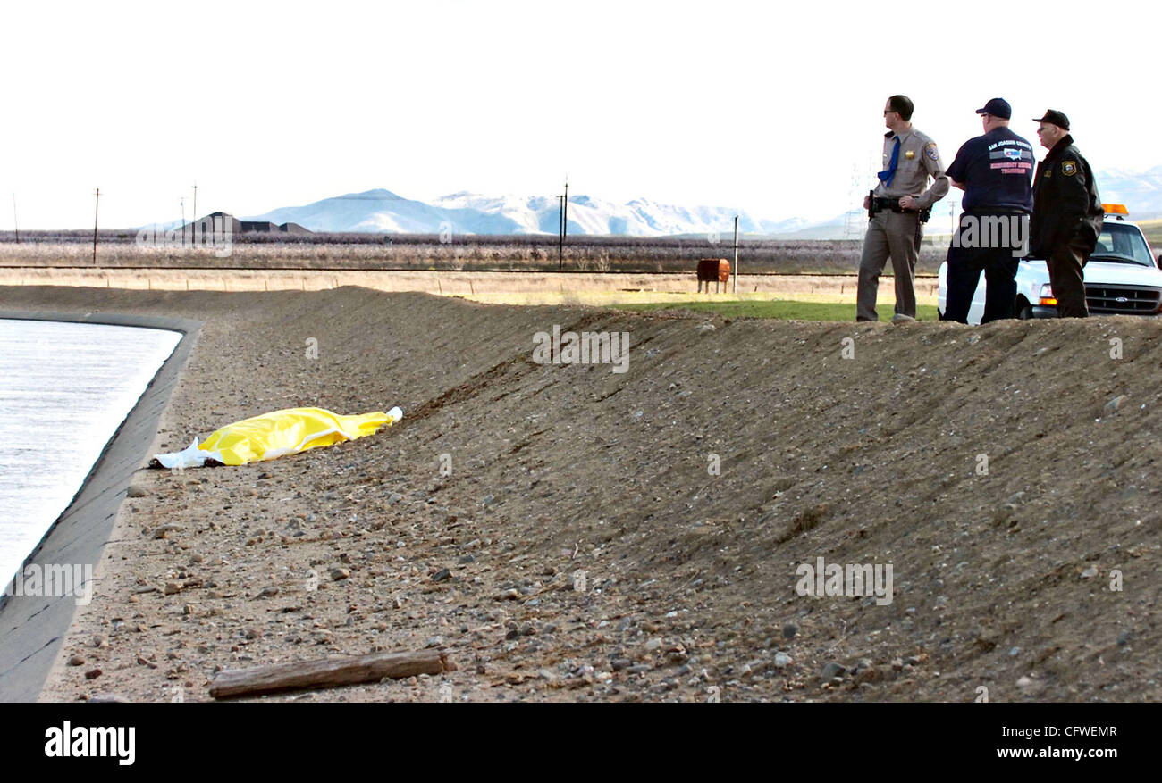Emergency workers wait for the coroner to arrive at the Delta Mendota ...